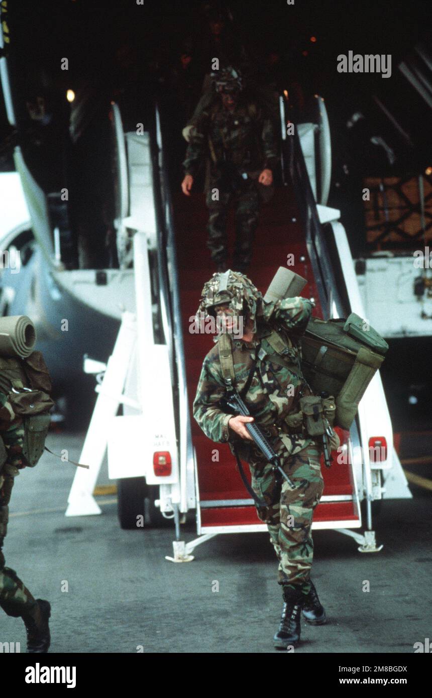 Soldiers of the 7th Light Infantry Division disembark from a C-5 Galaxy ...