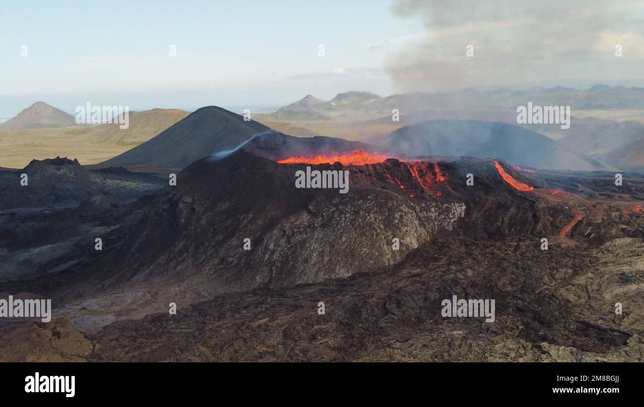 A landscape of erupting Mauna Loa Volcano in Hawaii with smoke and blue ...