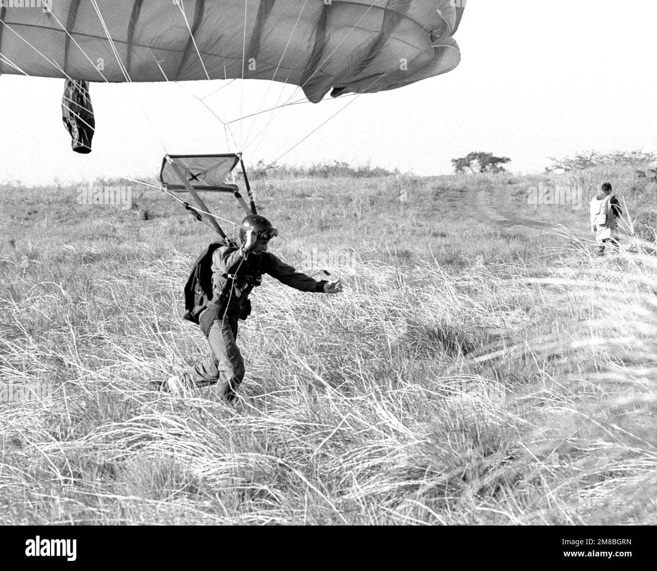 A member of Sea-Air-Land (SEAL) Team 8 makes a practice parachute ...