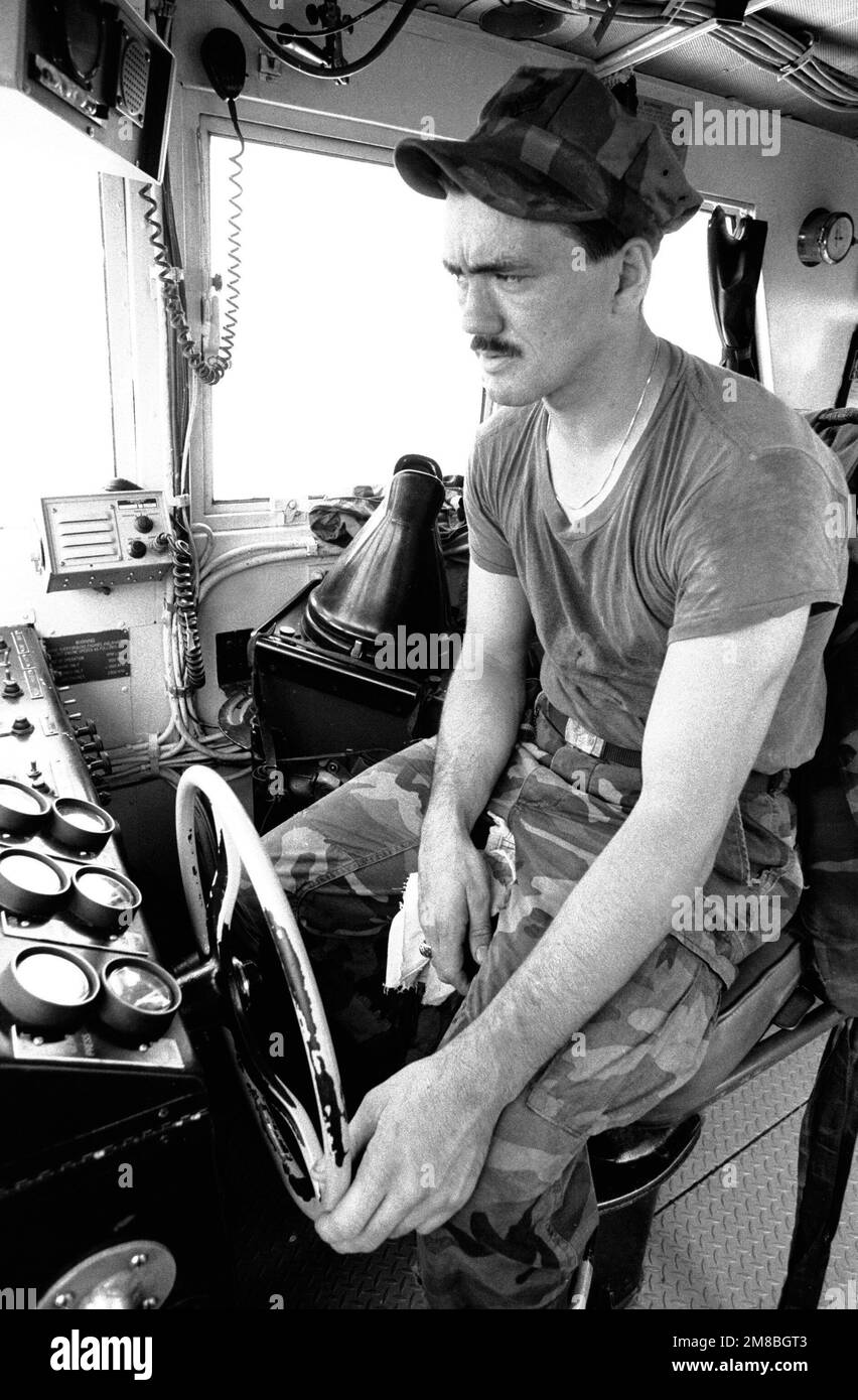 A member of Special Boat Unit 26 (SBU-26) pilots a PBR Mark 3 riverine ...