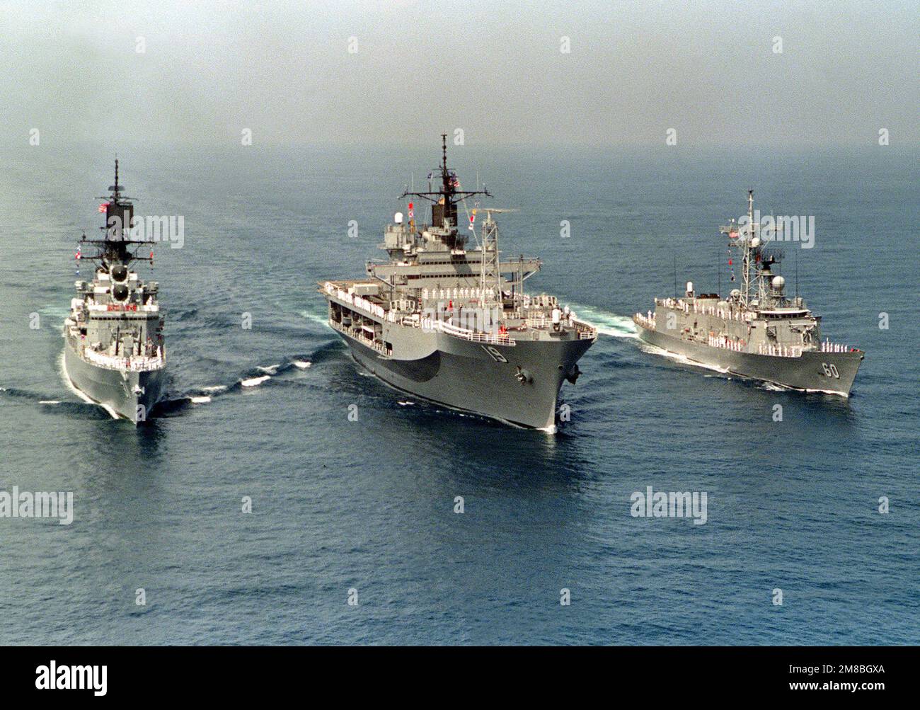 Officers and sailors man the rails of the amphibious command ship USS ...
