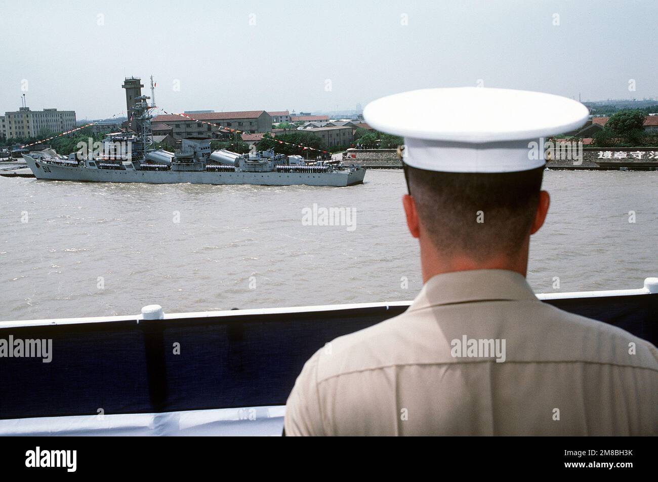 A Marine mans the rail of a 7th Fleet ship as it passes a Chinese ...