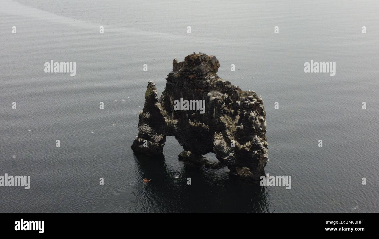 A landscape of Hvitserkur rocky basalt stack along the shore of the ...