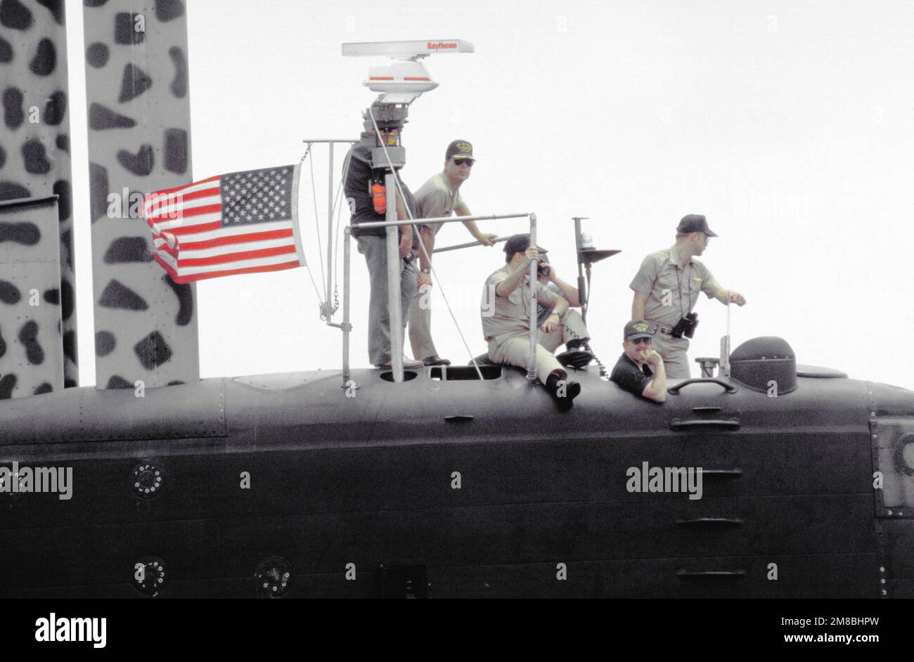 Officers and crewmen on the sail of the nuclear-powered attack ...