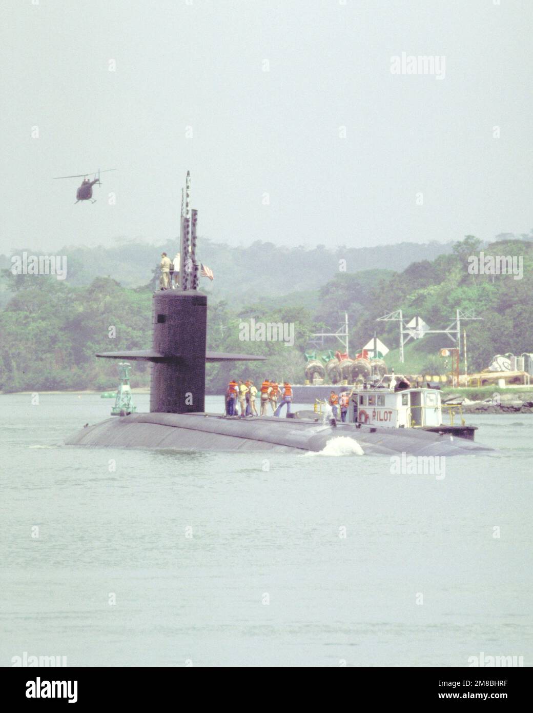 A tug helps guide the nuclear-powered attack submarine USS SEAHORSE ...
