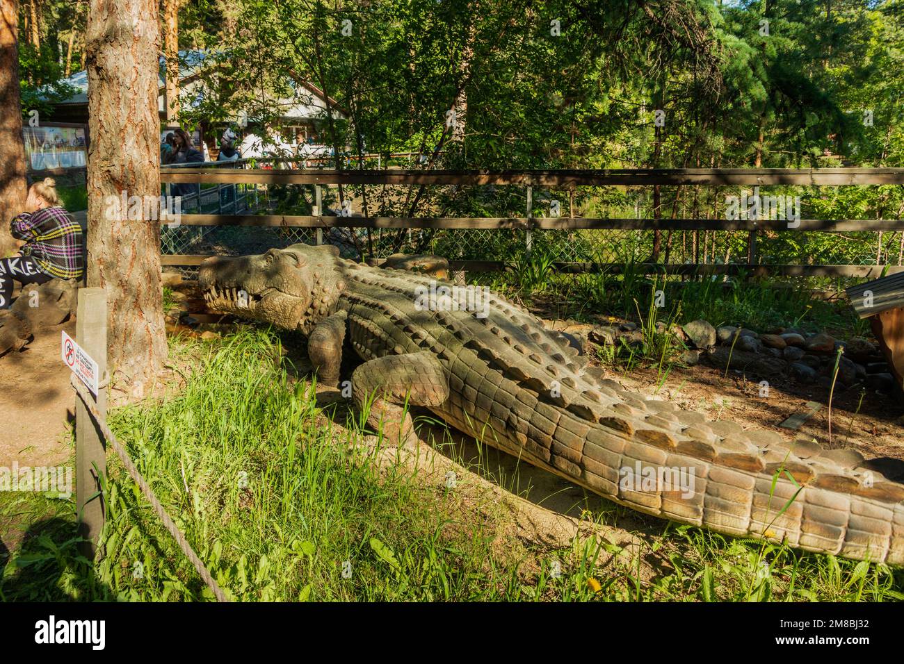 Chelyabinsk, Russia - June 01, 2022. A dinosaur figure stands in a city ...