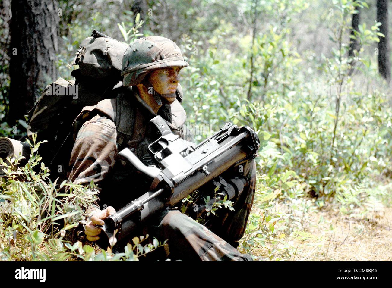 A Marine from Co. E, 2nd Bn., 4th Marines, holds a shoulder-launched ...