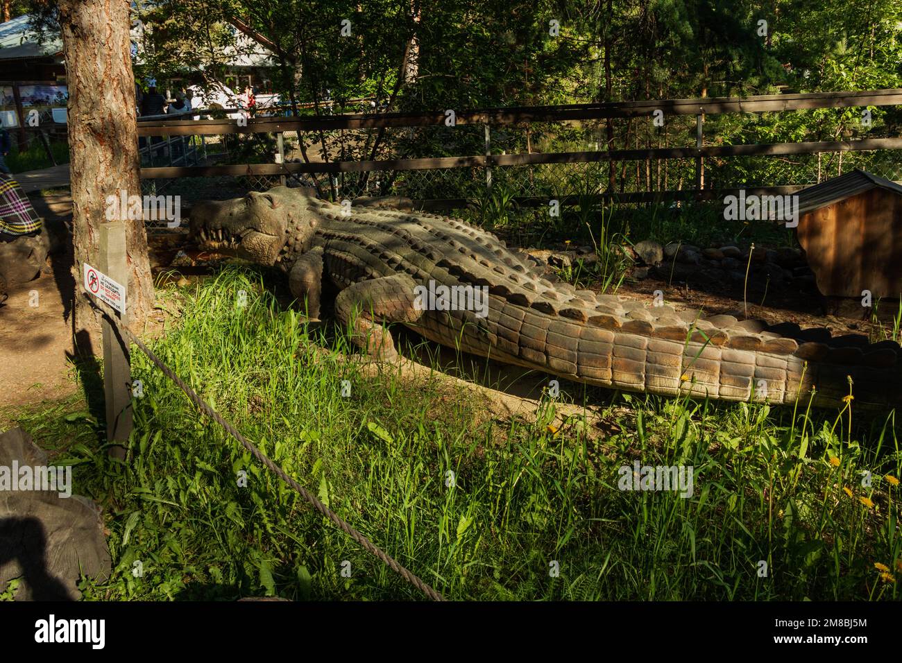 Chelyabinsk, Russia - June 01, 2022. A dinosaur figure stands in a city ...