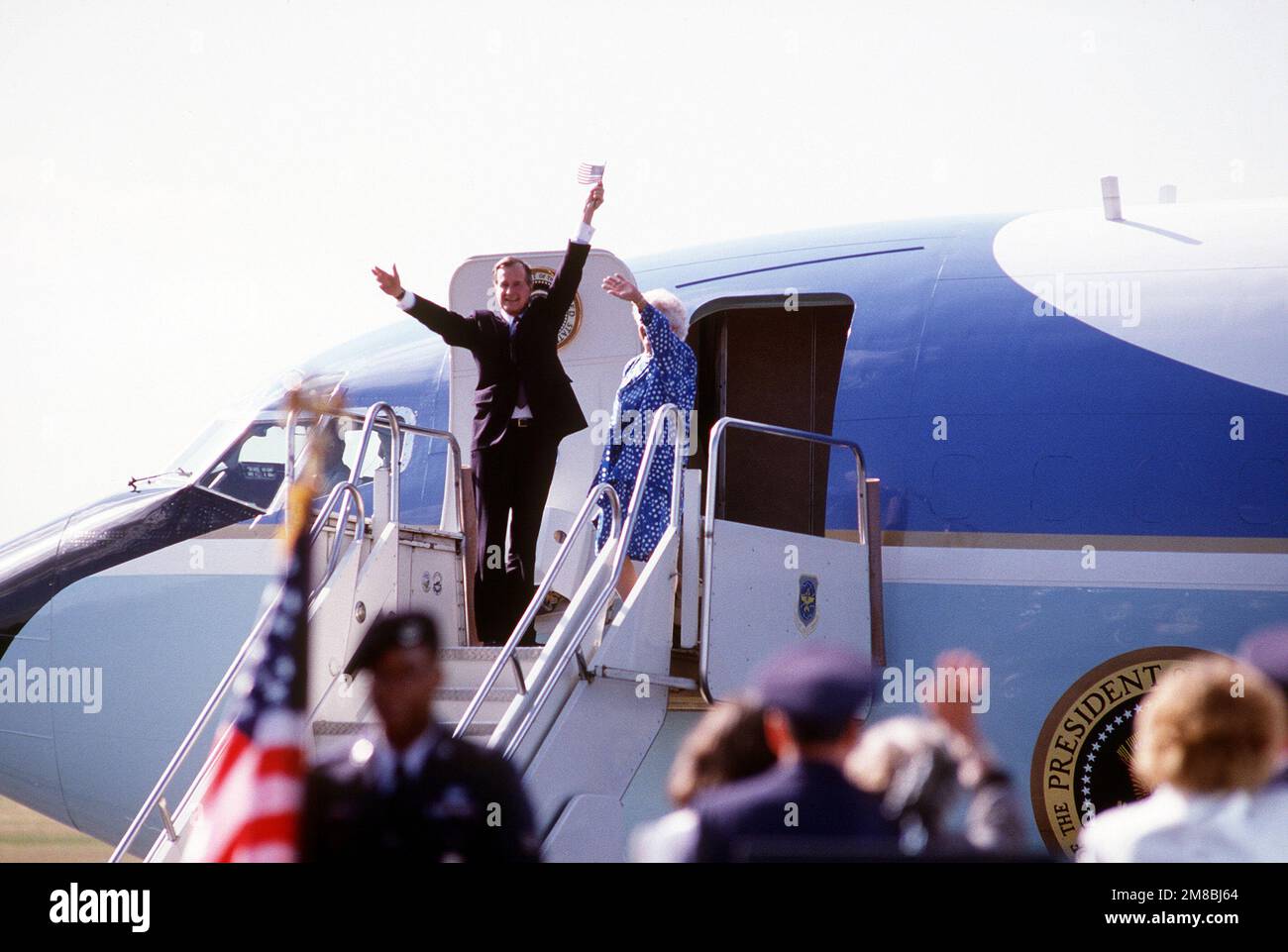 President George H.W. Bush and Barbara Bush wave to the crowd as they ...