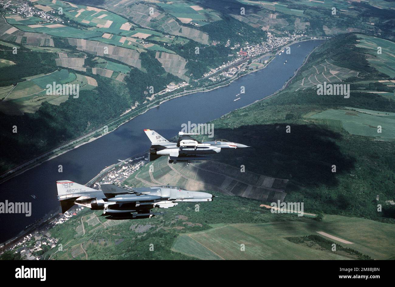 An F-4G Phantom II Wild Weasel aircraft, foreground, and an F-16C ...