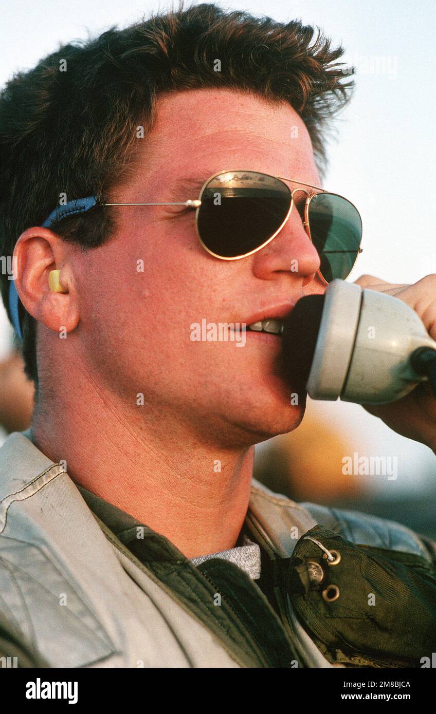 A landing signal officer (LSO) stands ready on the flight deck of the ...