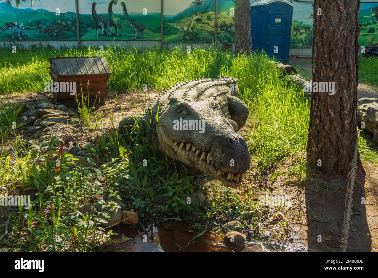 Chelyabinsk, Russia - June 01, 2022. A dinosaur figure stands in a city ...