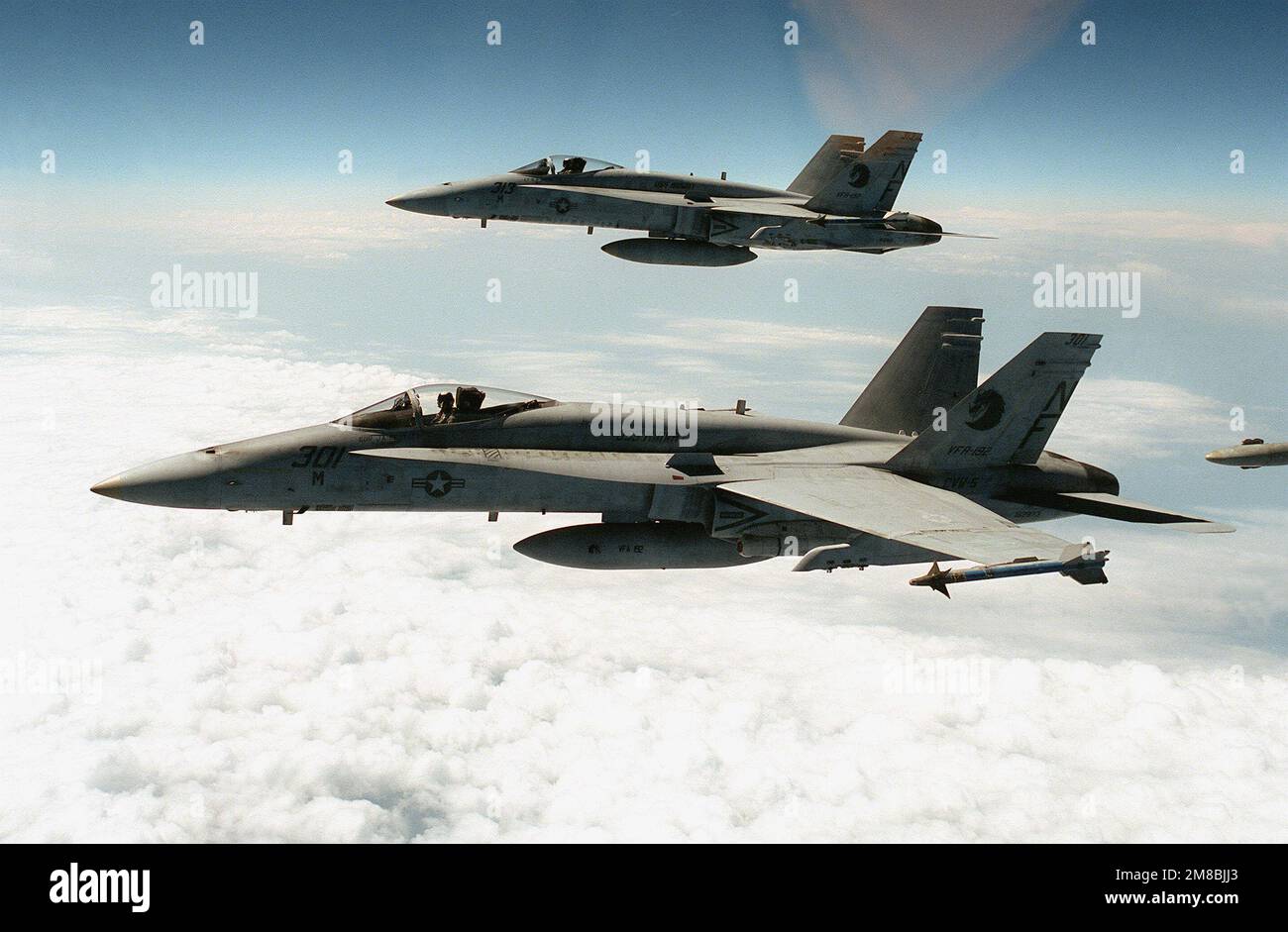 An air-to-air left side view of two F/A-18A Hornet aircraft from Strike ...