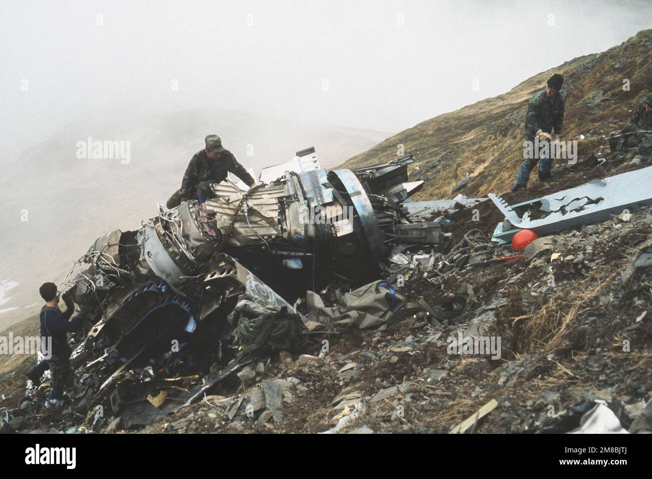 A rigging team prepares wreckage from the tail of a crashed F-15 Eagle ...