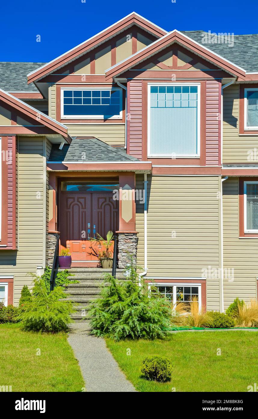 Main entrance of big family house with concrete door steps in front ...