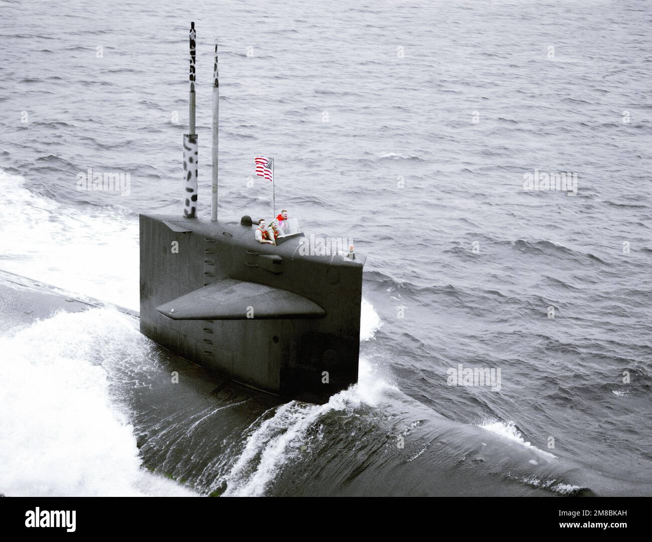 Crew members man the bridge on the sail of the nuclear-powered attack ...