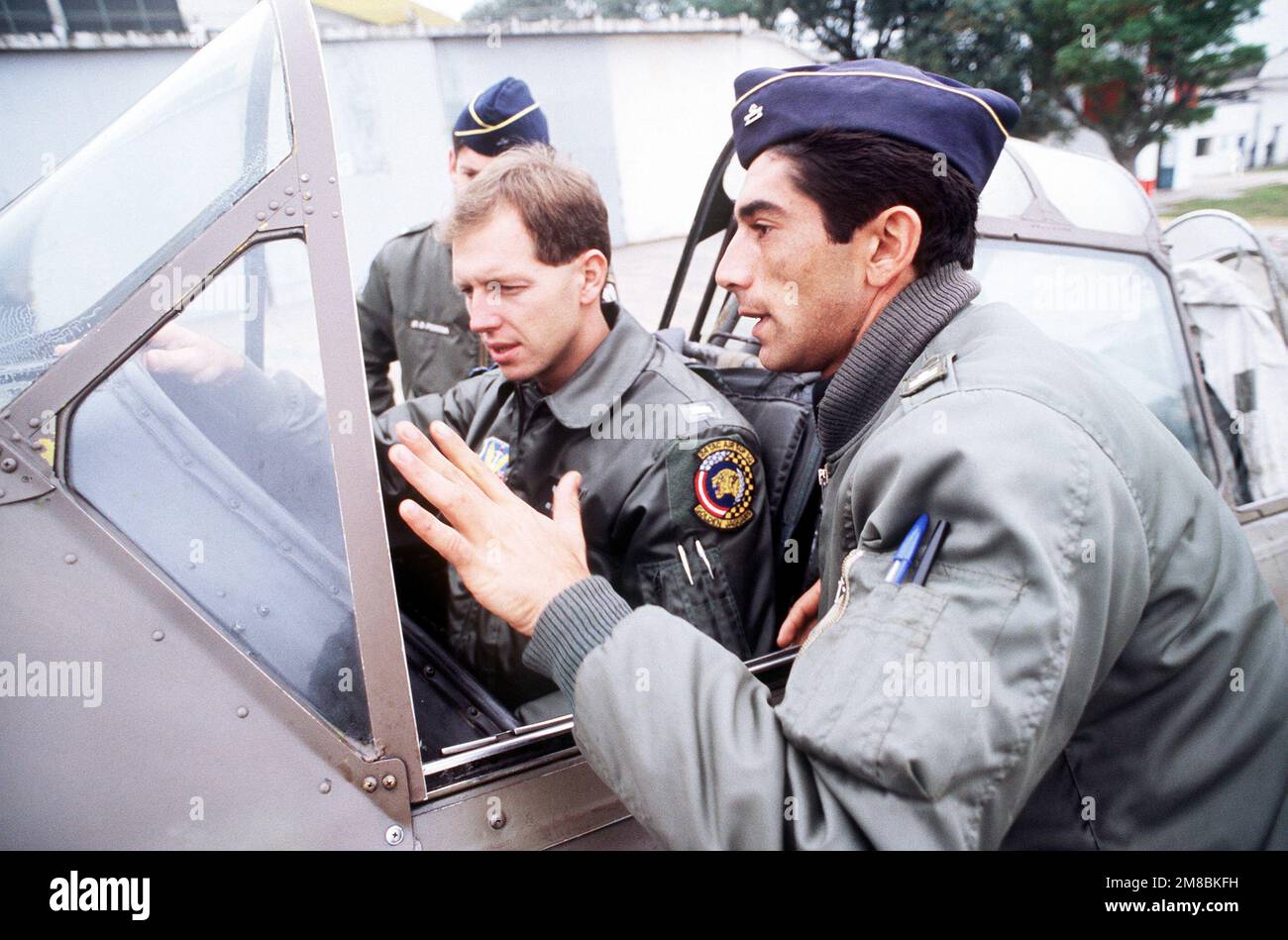 Uruguayan pilot LT Manuel Atorro briefs LT Michael Tutt, 24th Tactical ...