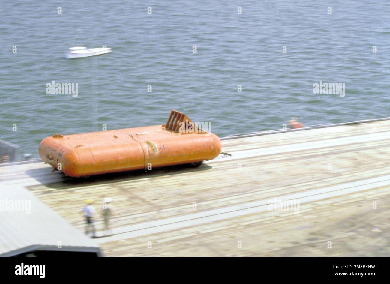An 82,700-pound test sled speeds down the No. 4 catapult on the flight ...