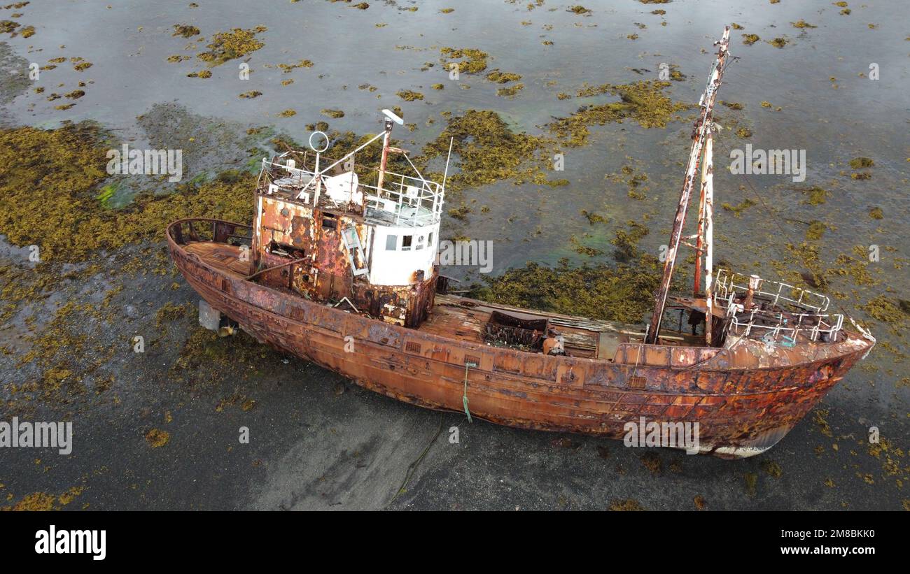 An abandoned ship on mossy green coast island by the sea Stock Photo ...