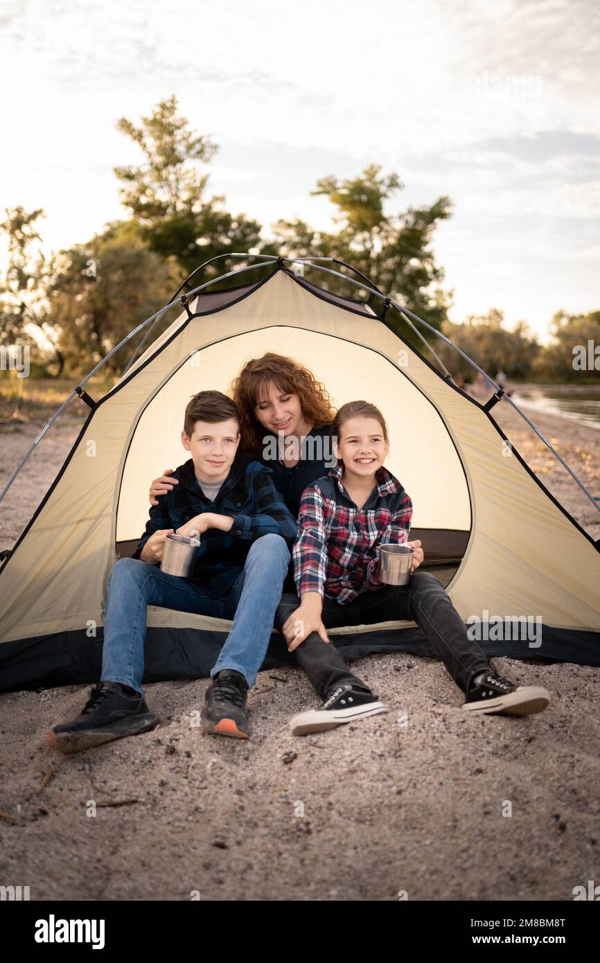 Camp in the tent. Portrait of happy family on the camping. Hike ...