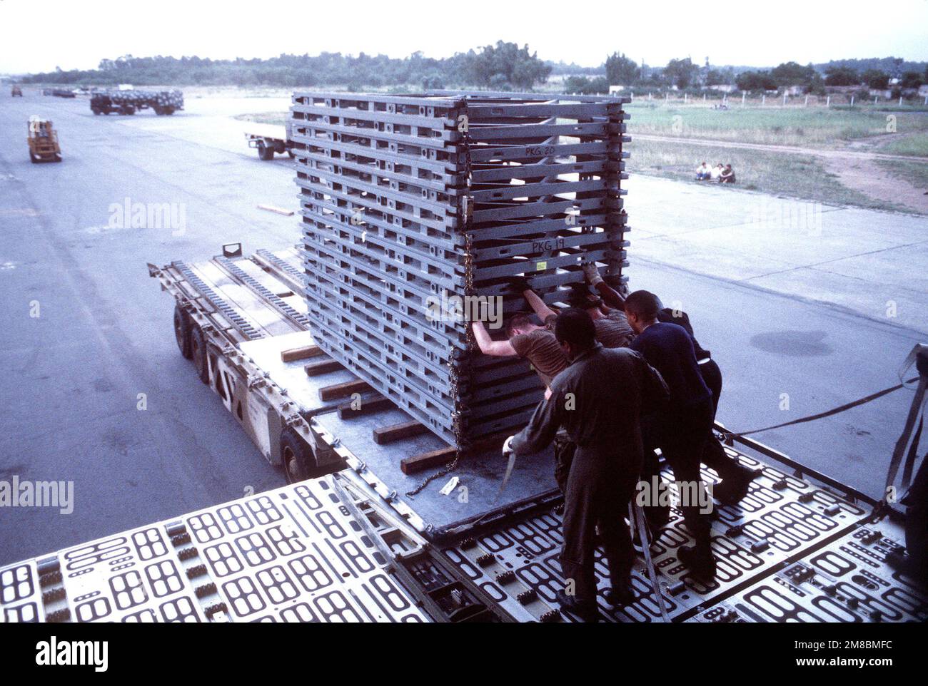 Airmen unload sections of a Bailey Bridge from one of two 709th ...