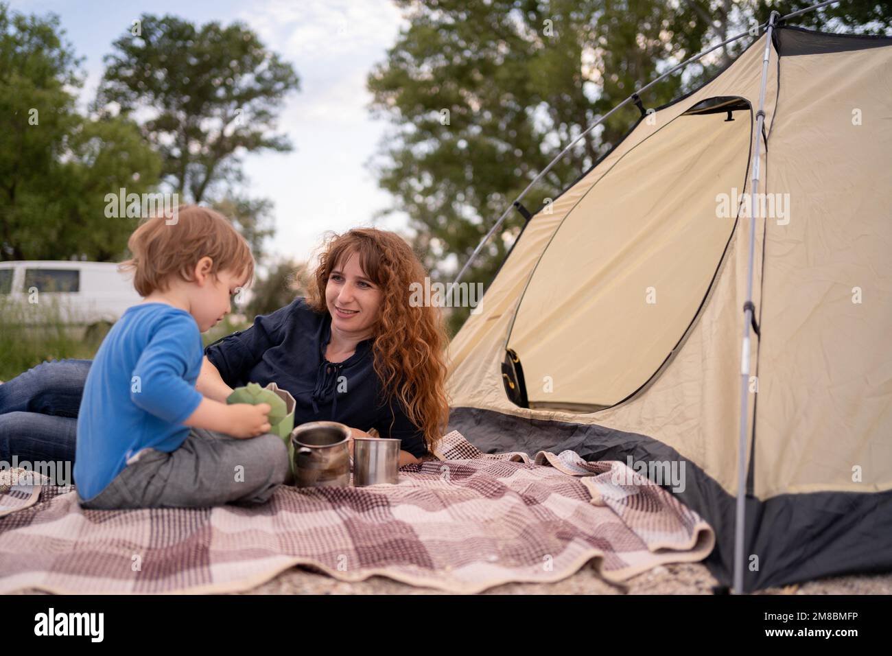 mother and son near tent on the nature. Hiking activity, travel ...