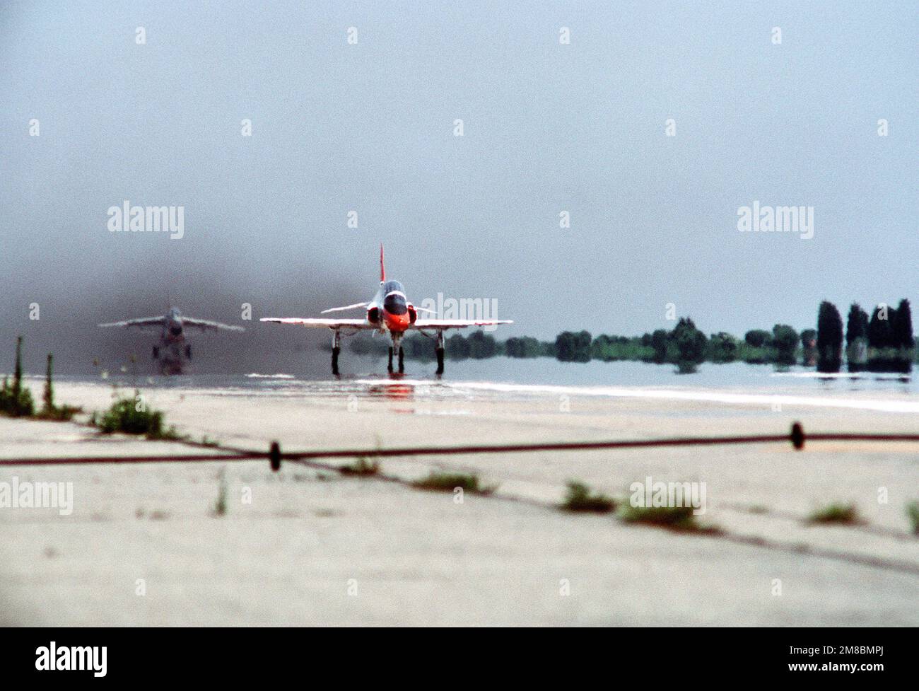 Followed by an A-7 Corsair aircraft, a T-45A Goshawk aircraft rolls ...