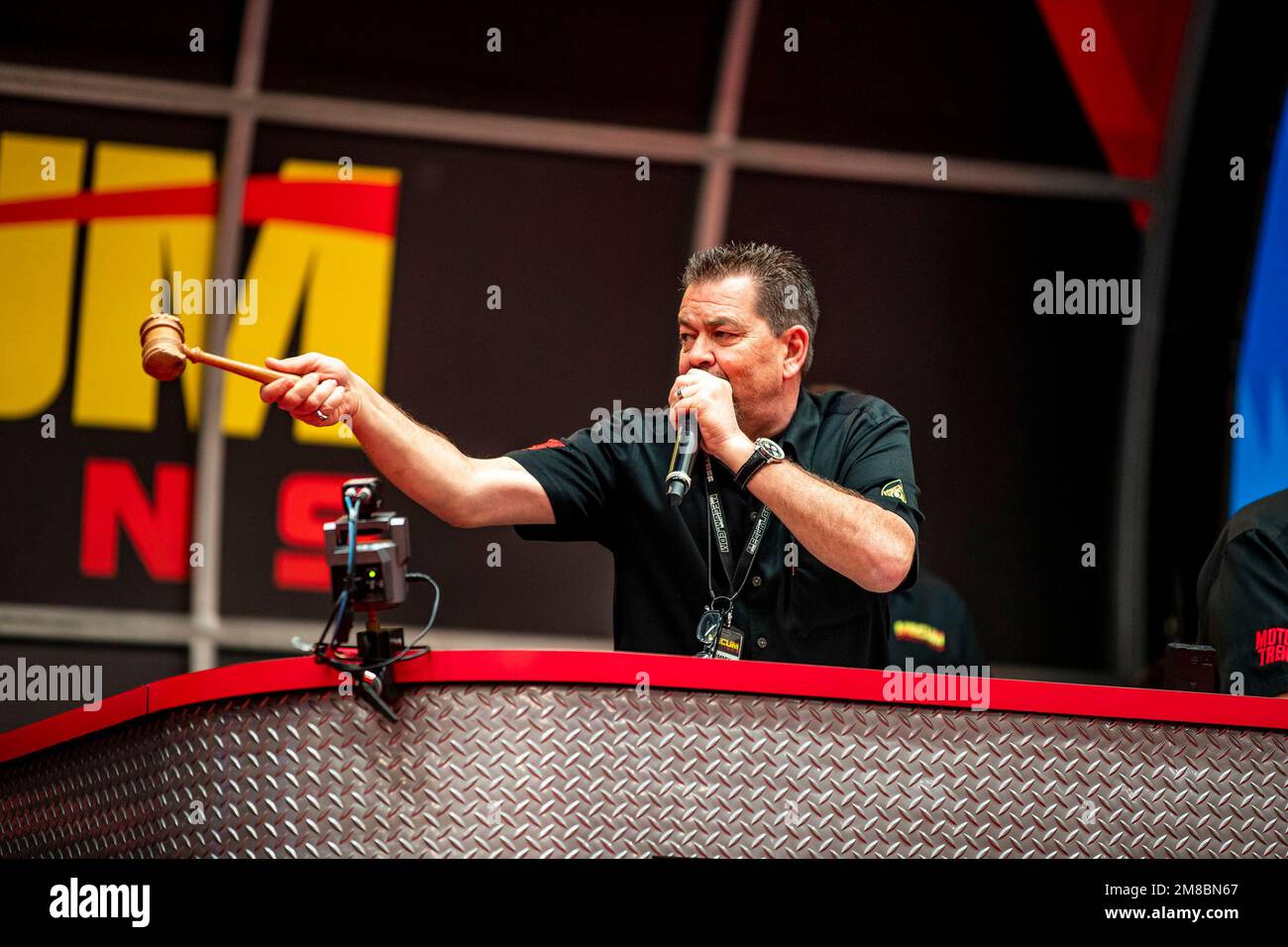 Lead auctioneer Jimmy Landis takes bids for collector cars as they roll ...