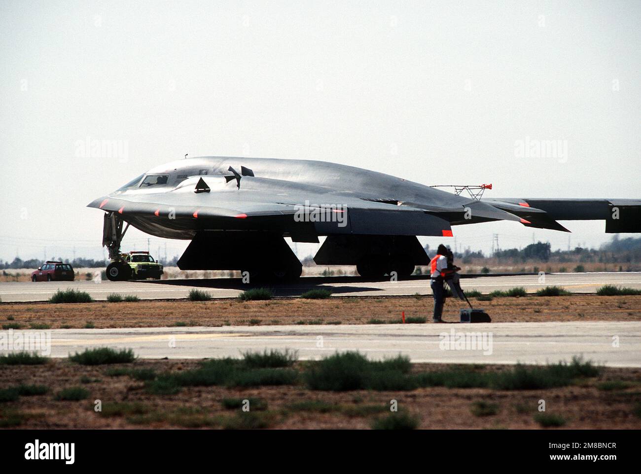 A cameraman sets up near a B-2 advanced technology bomber as the ...