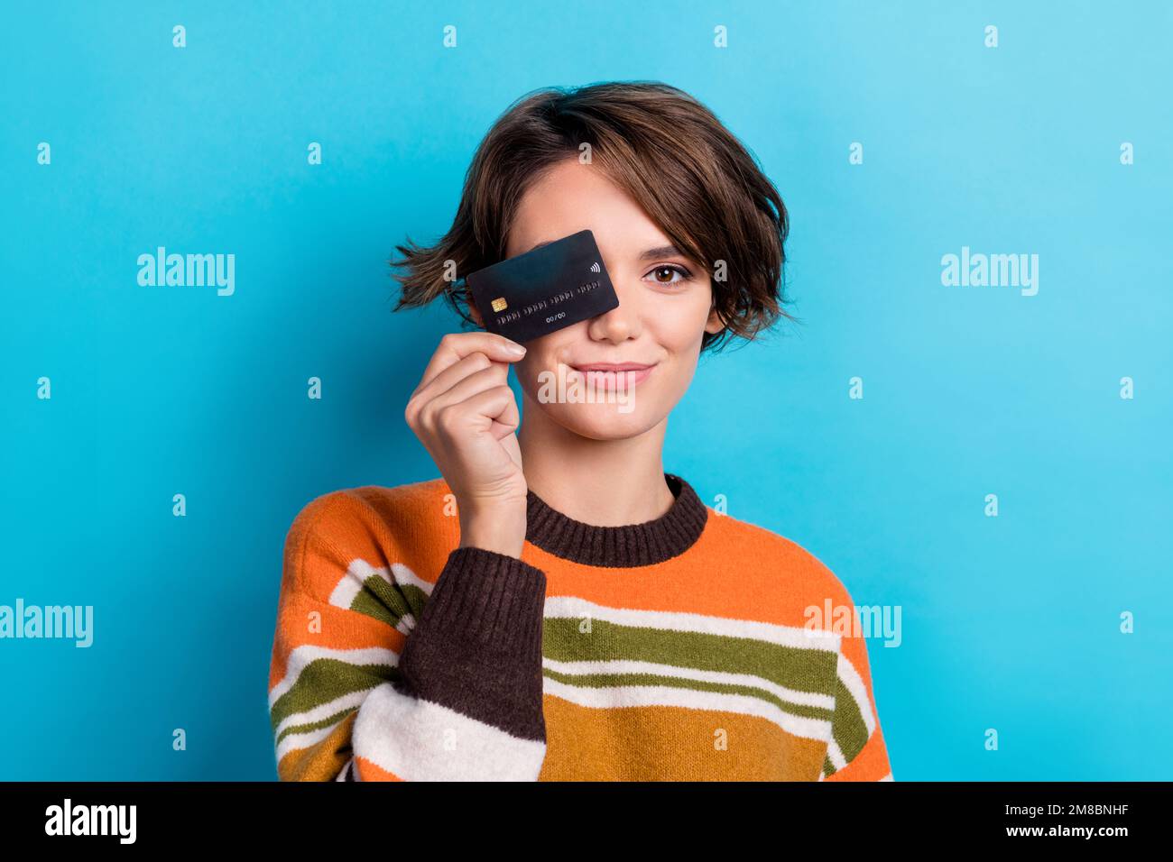 Photo of dreamy cheerful lady wear striped sweater holding bank card ...