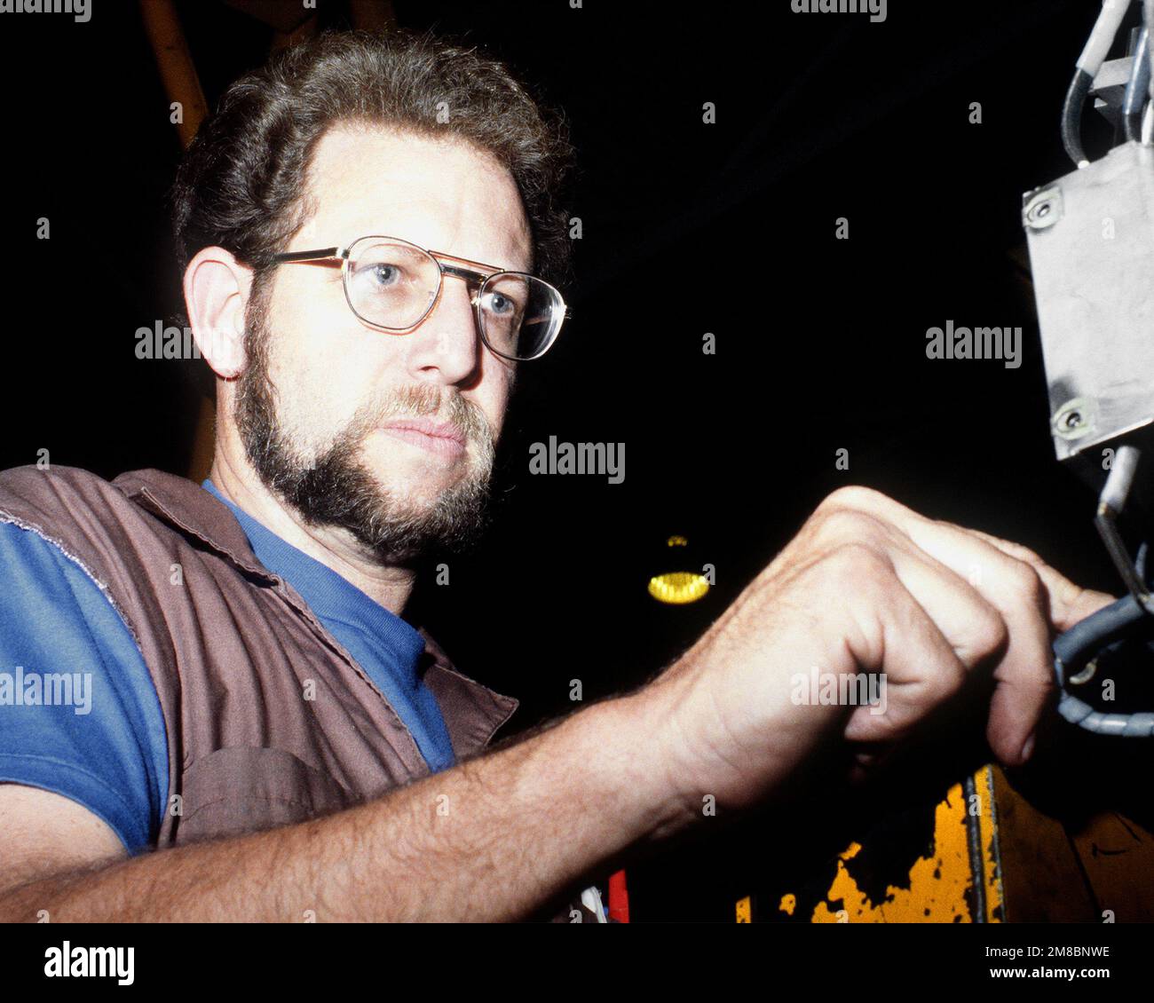 A civilian works on a TF-41 engine of an A-7 Corsair II aircraft in the ...