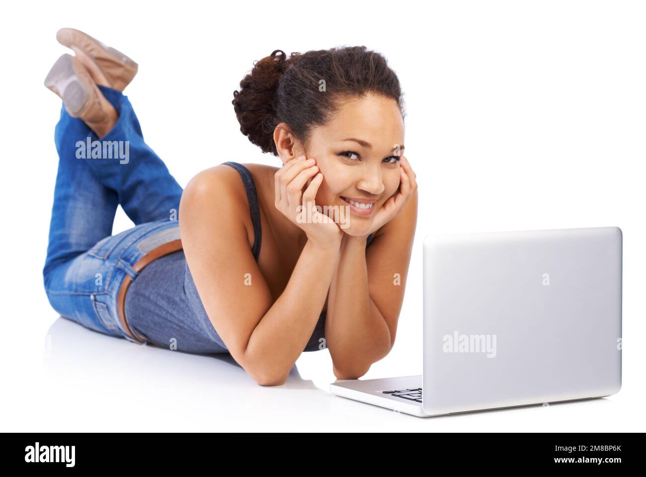 Portrait, laptop and black woman on floor of studio, isolated white ...