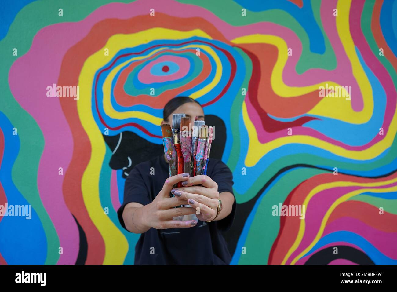 wall painting, Beautiful woman painting the wall colorfully Stock Photo ...