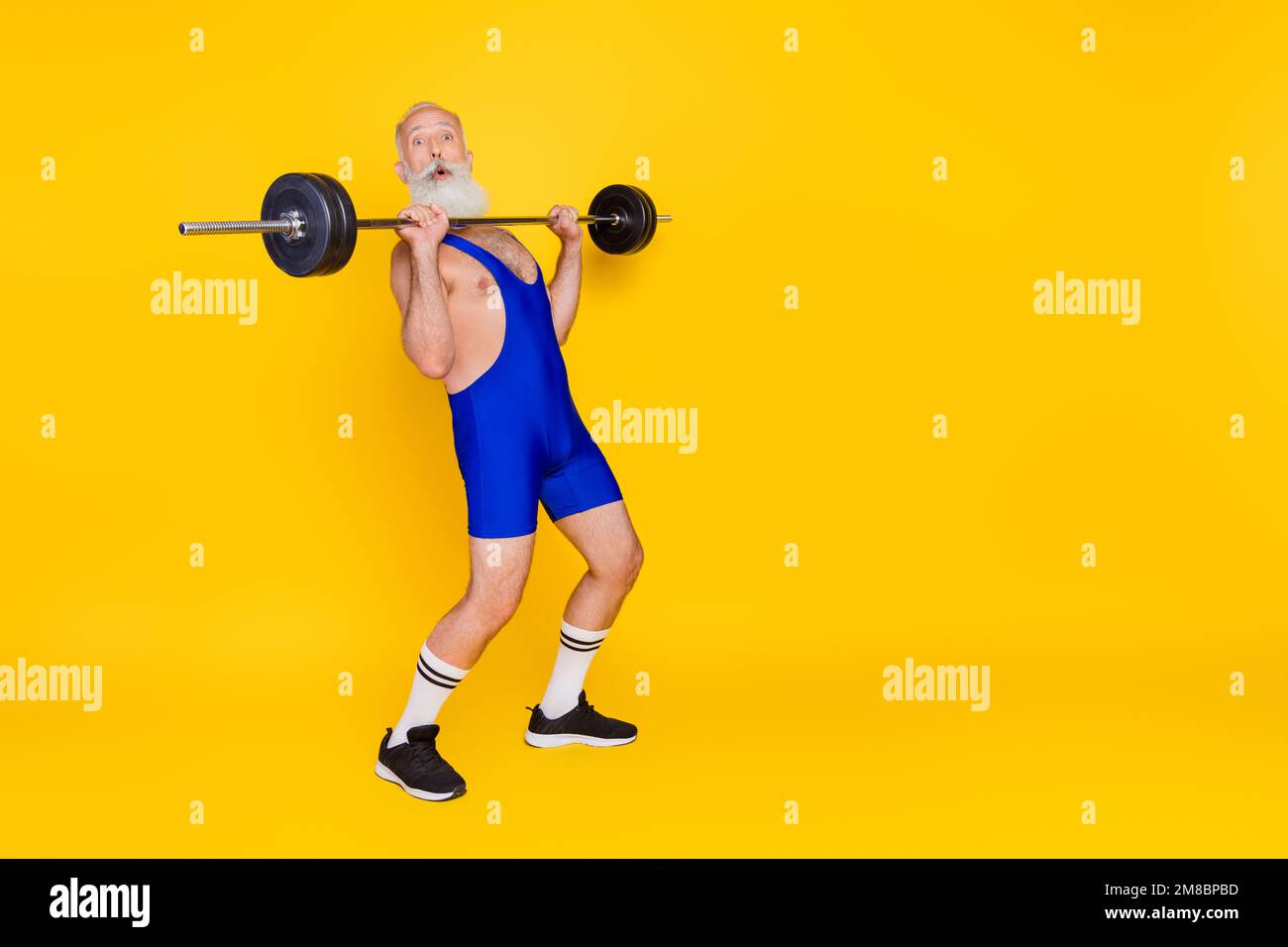 Full length portrait of sportive charismatic aged man press lifting ...