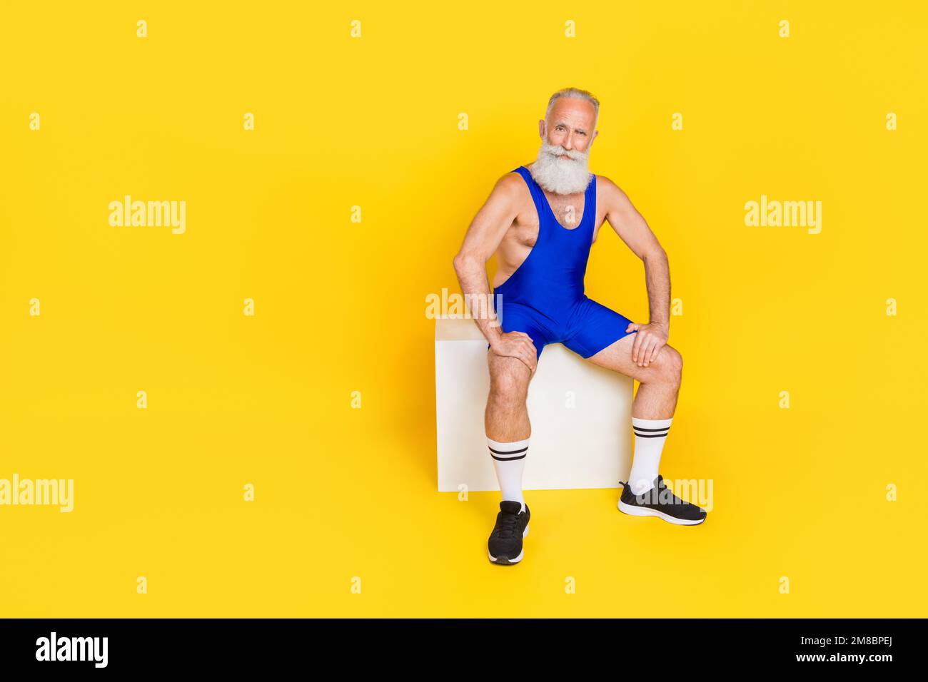 Full size portrait of extravagant sporty aged person sit podium empty ...