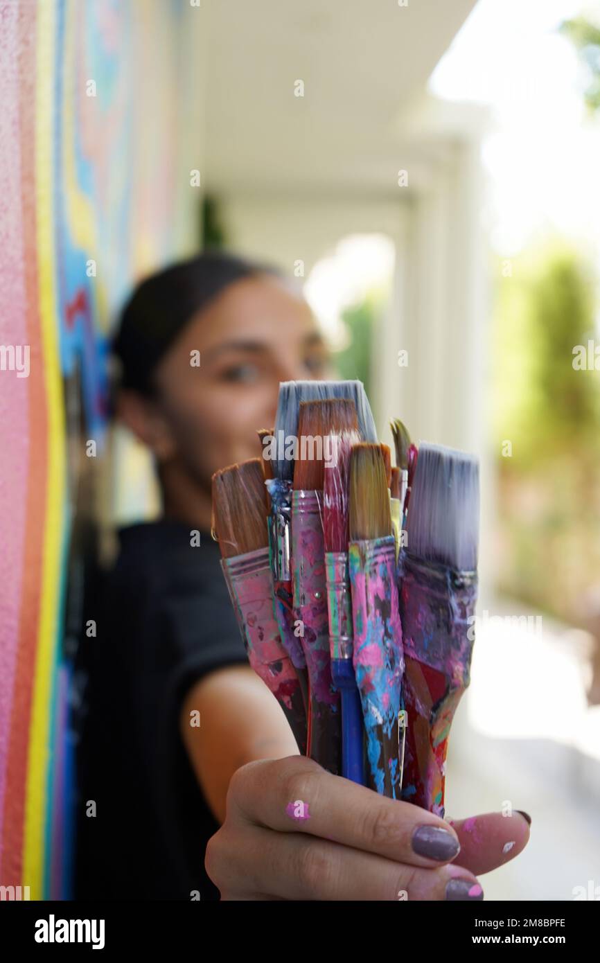 wall painting, Beautiful woman painting the wall colorfully Stock Photo ...