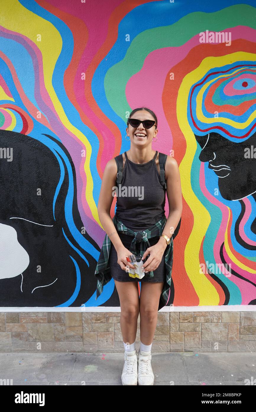 wall painting, Beautiful woman painting the wall colorfully Stock Photo ...