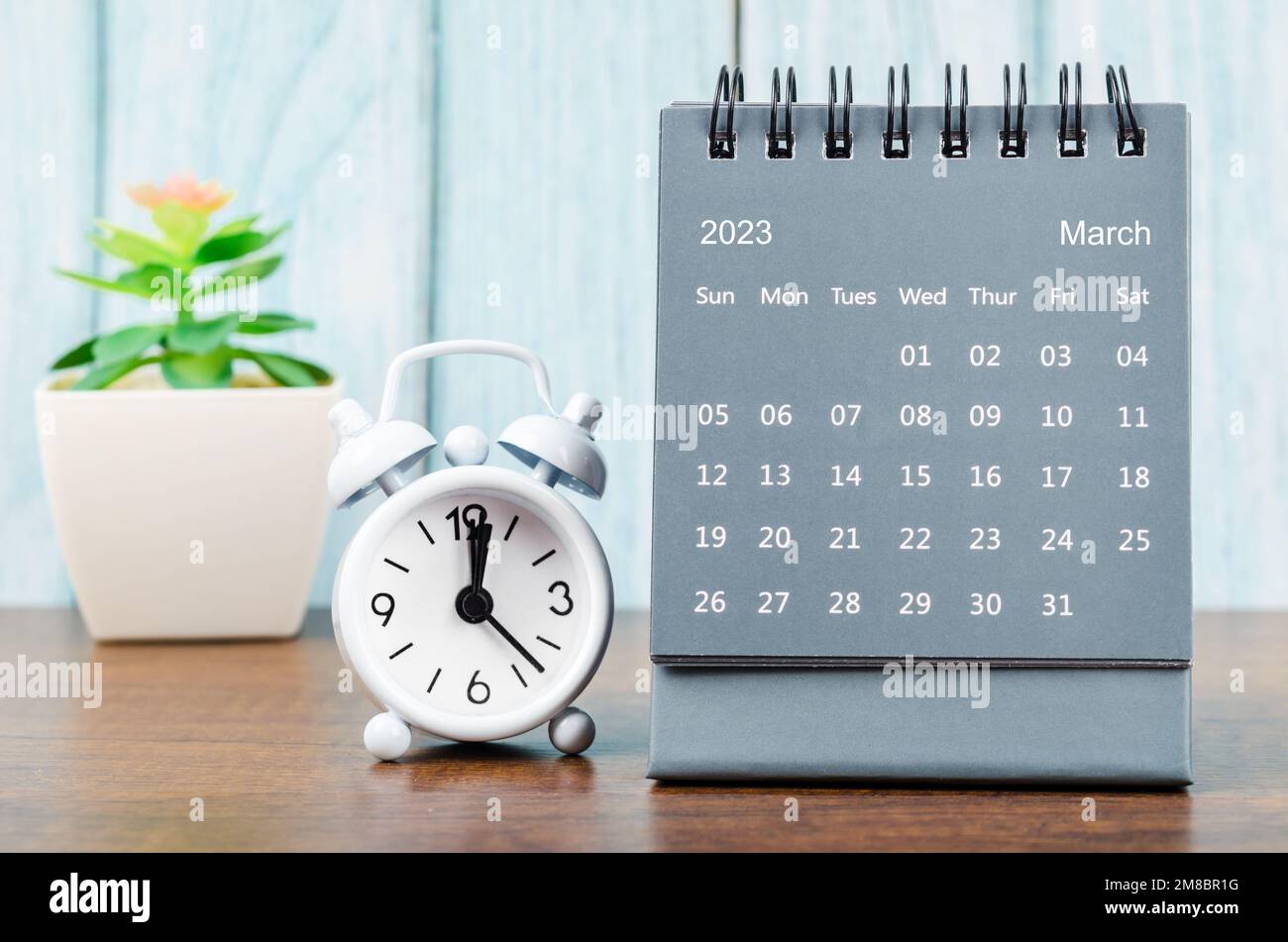 March 2023 Monthly desk calendar for 2023 year with alarm clock on blue ...
