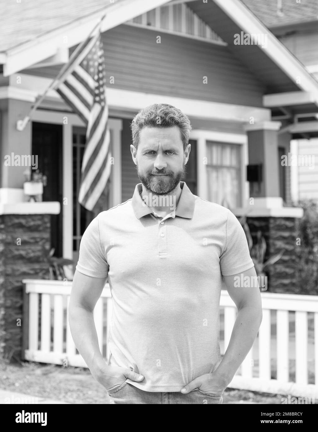 bearded man realtor selling or renting house with american flag ...