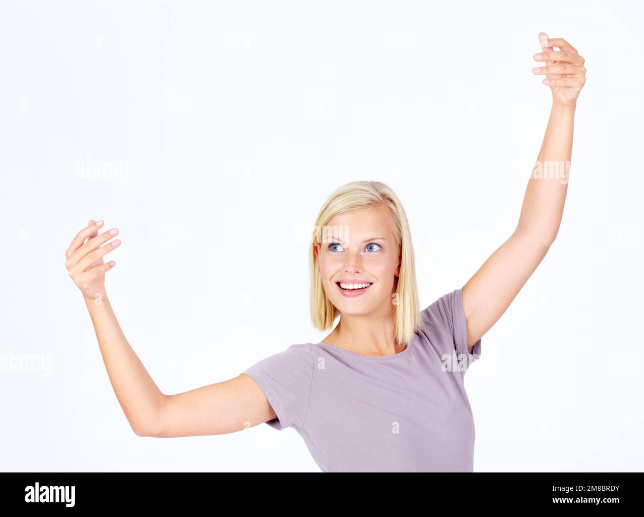 Woman, happy dance and studio by white background with smile, artistic ...