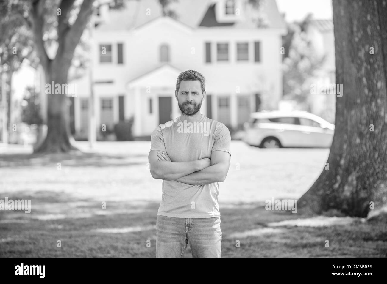 confident unshaven guy standing near new home, buying house Stock Photo ...