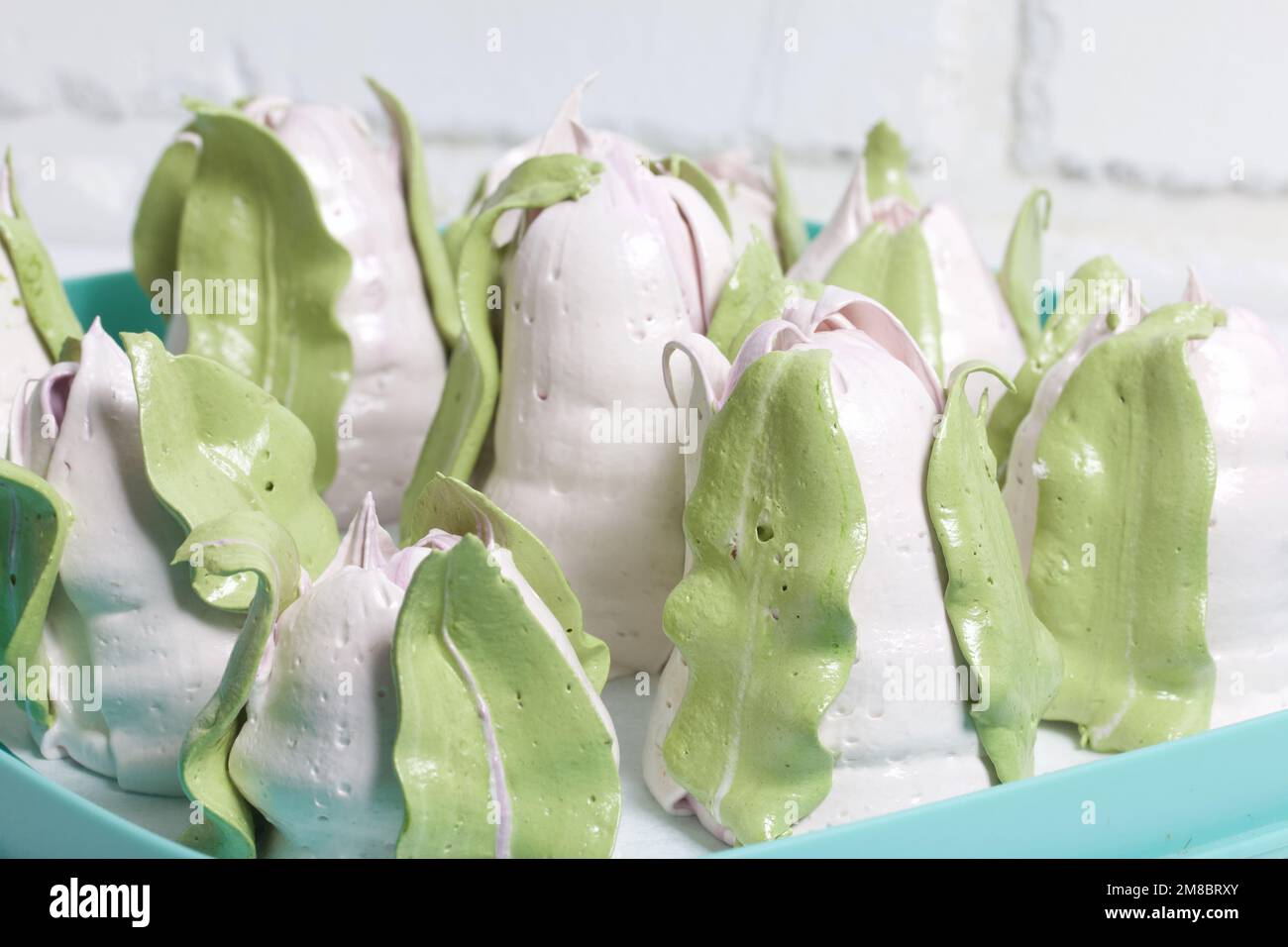Homemade zephyr tulips dry on a tray. On a white background. Close-up ...