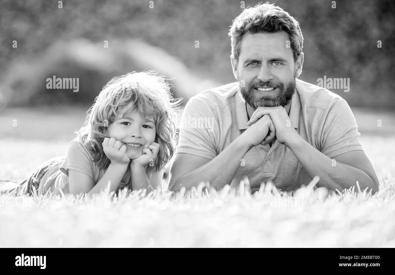 smiling father and son having fun in park. family value. childhood and ...