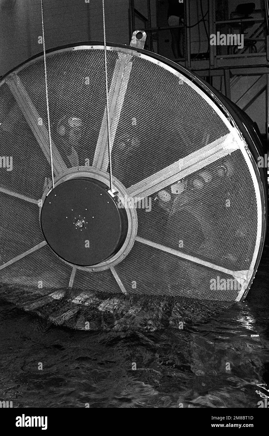 Aviators sit in a 9D5 multiplace underwater egress trainer as the ...