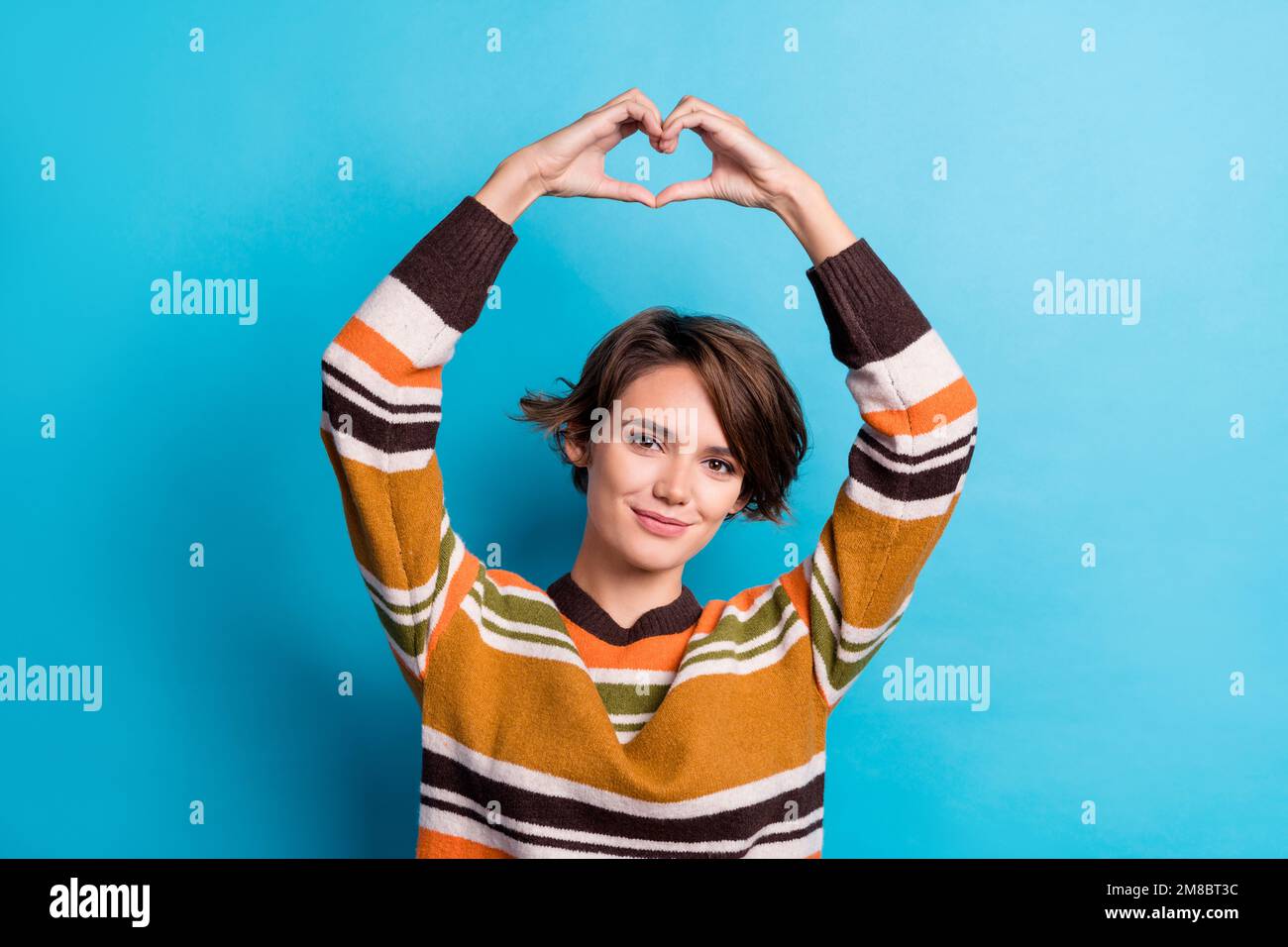 Photo of positive pretty lady wear striped sweater smiling rising arms ...