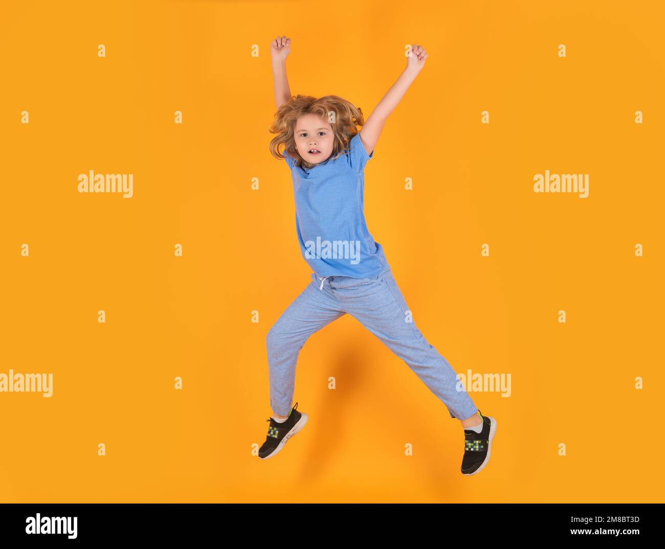 Boy jumping. Full size of kid boy have fun jump up isolated over yellow ...
