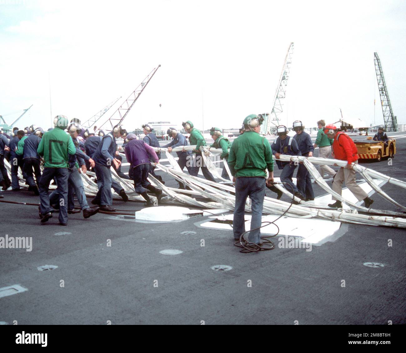 Flight deck crew members on the nuclear-powered aircraft carrier USS ...