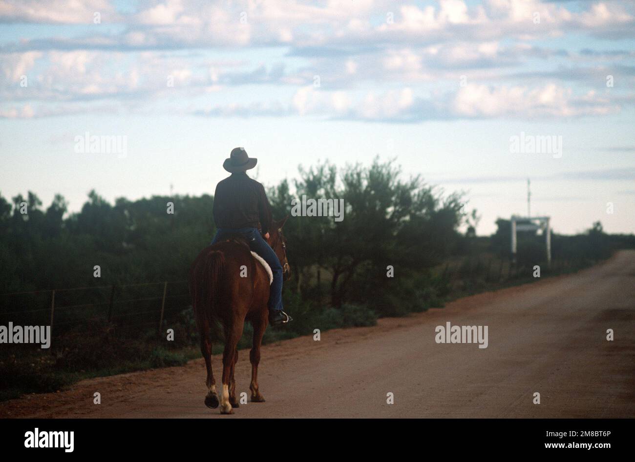 Photographer's Mate Clint Eastman heads back to the stables following ...
