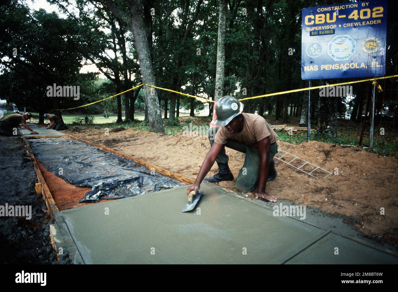 A Seabee of Construction Battalion Unit 402 (CBU 402) uses a steel ...