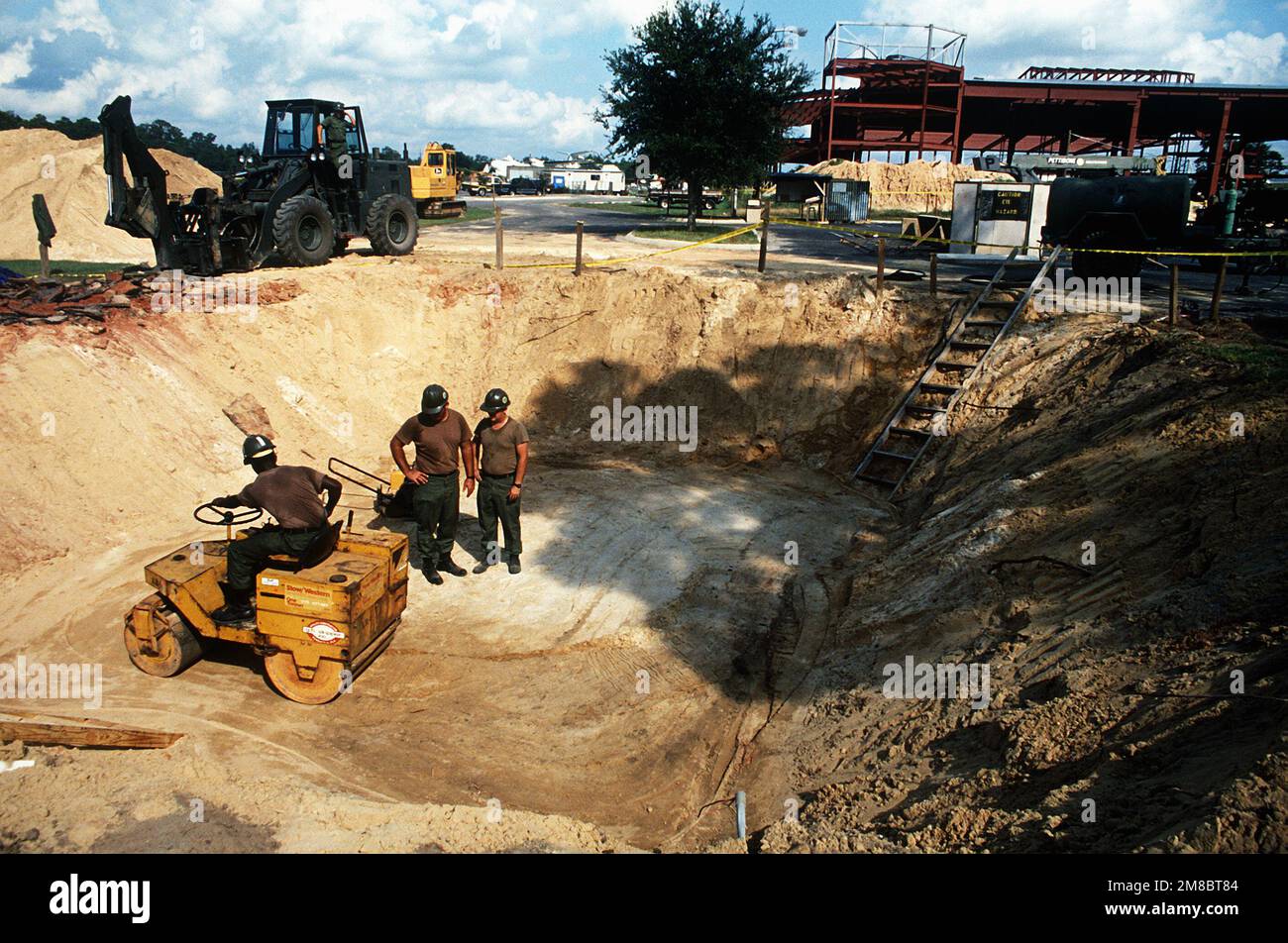 A Seabee of Construction Battalion Unit 402 (CBU 402) uses a road ...